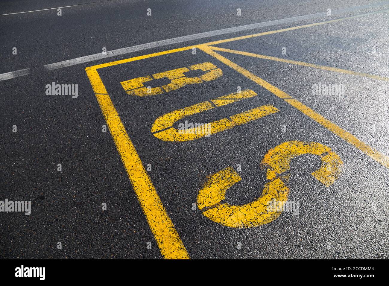 Paint on the road as marking of bust stop and station. Yellow lines and ...