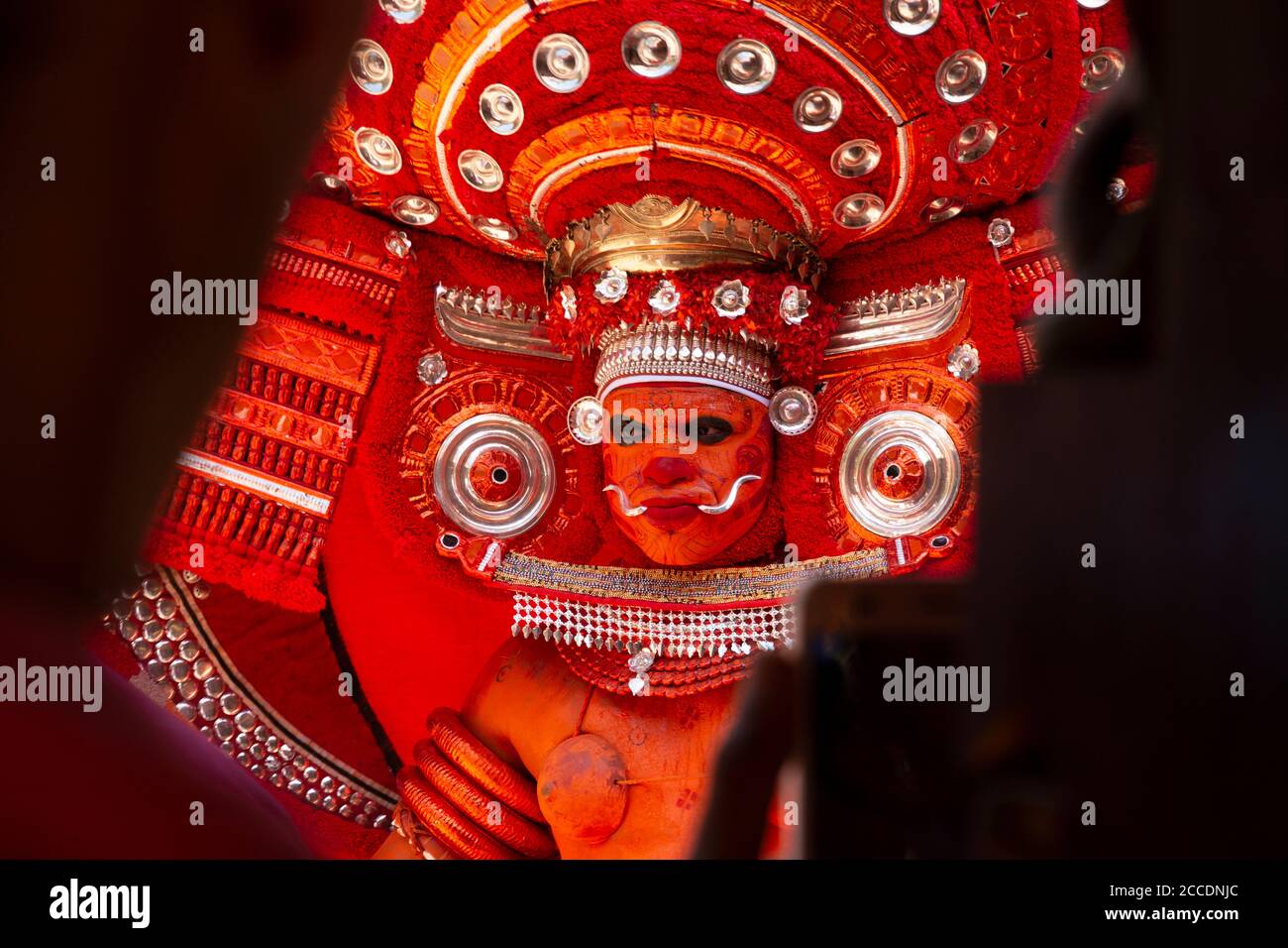 Traditional Theyyam performer adorned in elaborate costume and makeup ...