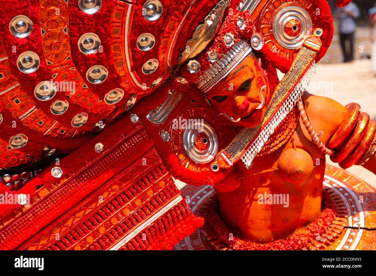 Traditional Theyyam performer adorned in elaborate costume and makeup ...