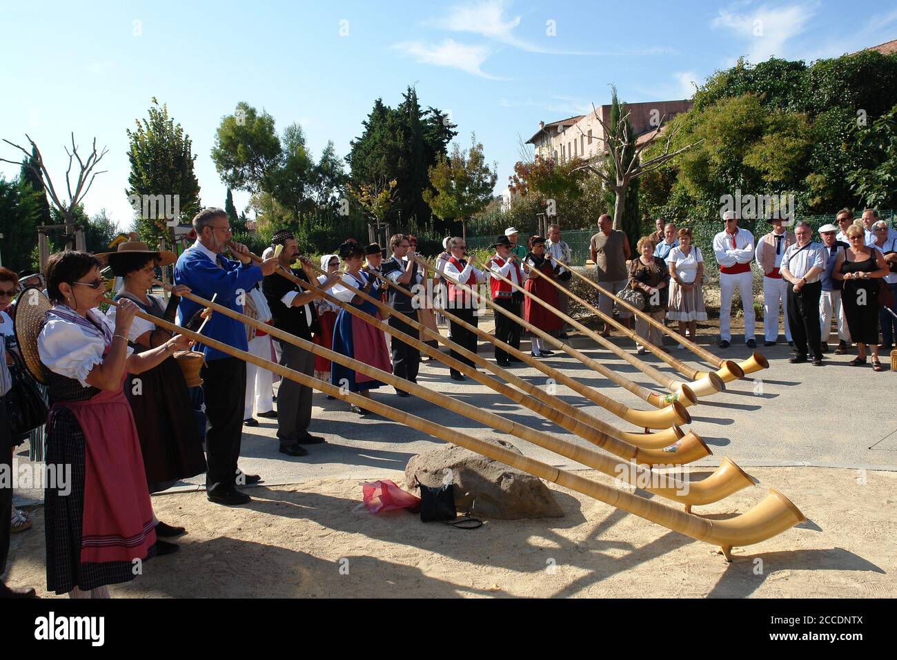 Swiss folk group playing the alphorn during the olive tree festival in ...