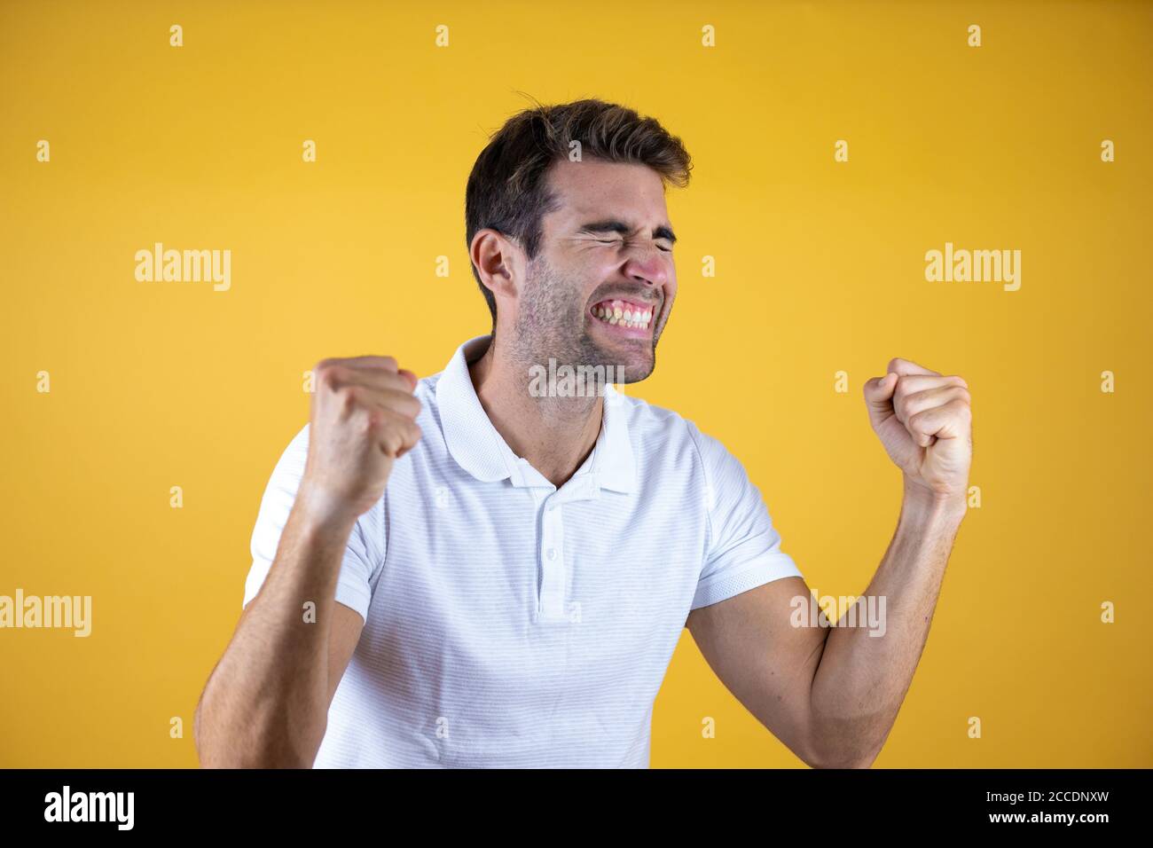 Young handsome man over yellow isolated background very happy and ...