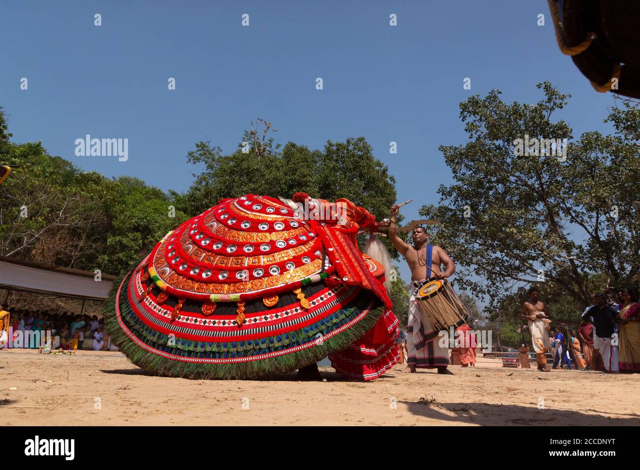 Traditional Theyyam performer adorned in elaborate costume and makeup ...