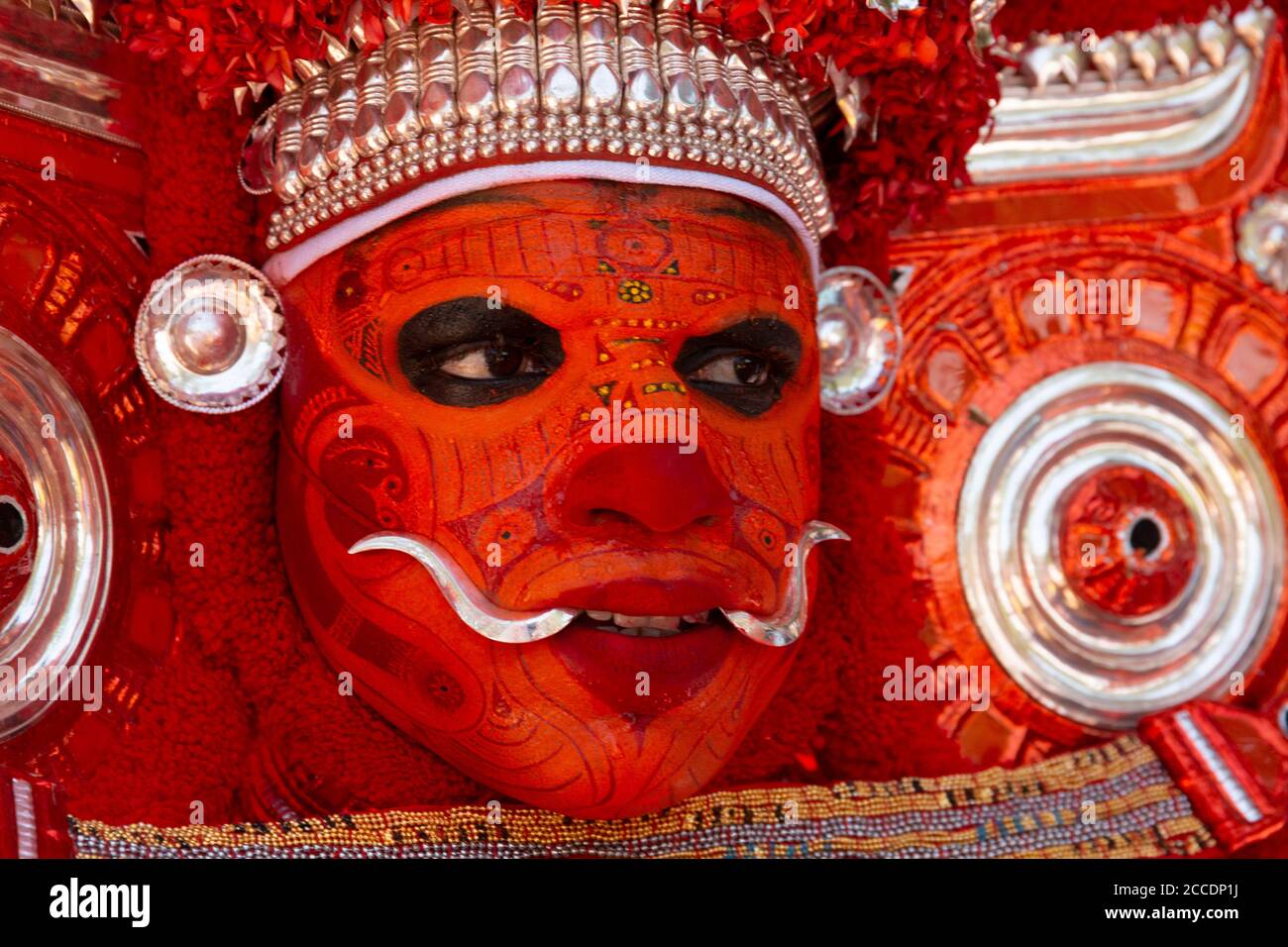 Traditional Theyyam performer adorned in elaborate costume and makeup ...