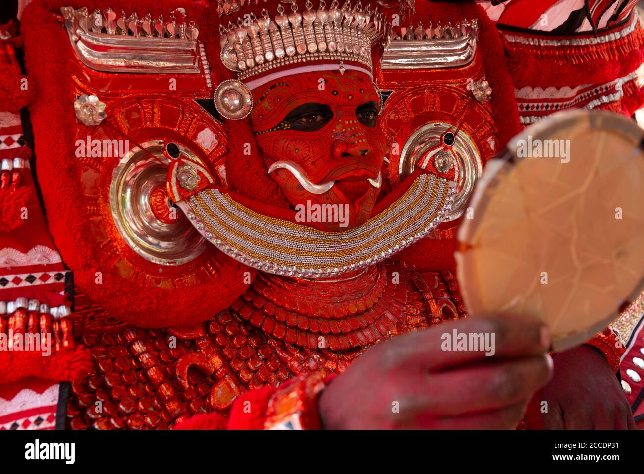 Traditional Theyyam performer adorned in elaborate costume and makeup ...