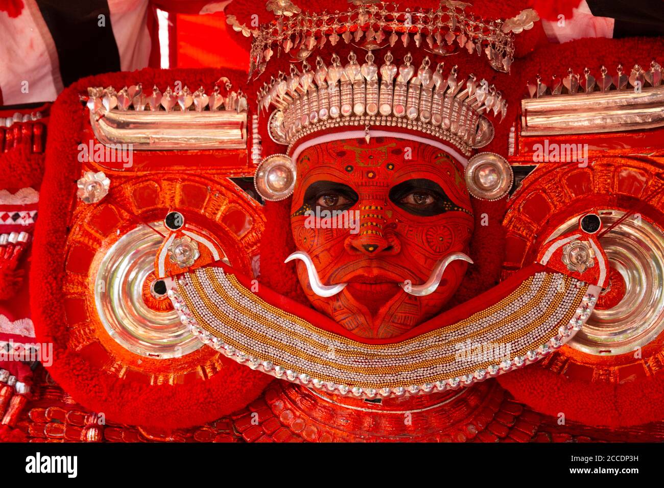 Traditional Theyyam performer adorned in elaborate costume and makeup ...