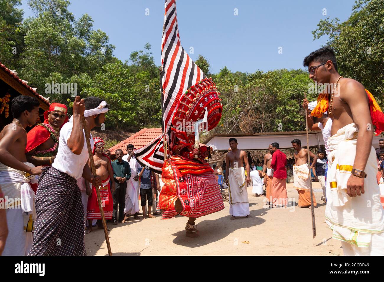Traditional Theyyam performer adorned in elaborate costume and makeup ...