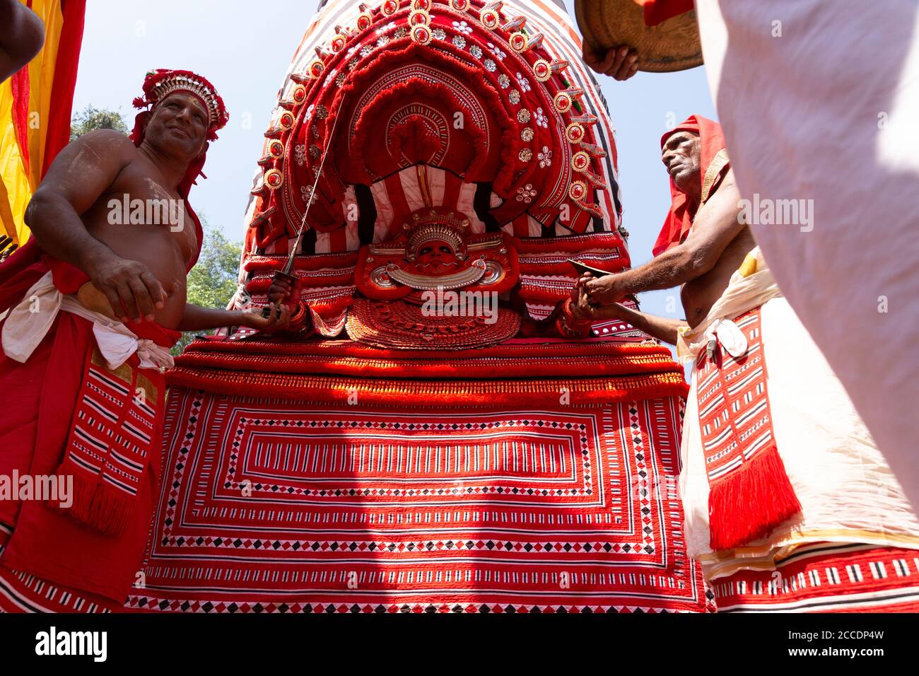 Traditional Theyyam performer adorned in elaborate costume and makeup ...