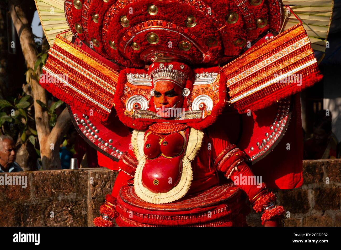 Traditional Theyyam performer adorned in elaborate costume and makeup ...