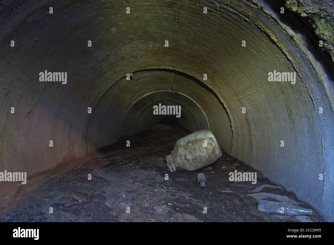 Round concrete sewer tunnel full of sludge and garbage Stock Photo - Alamy