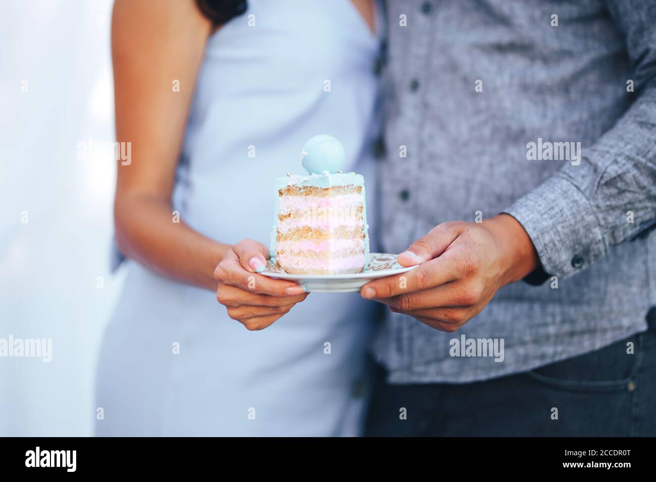 Young couple are hugging and holding a plate with a piece of cake Stock ...