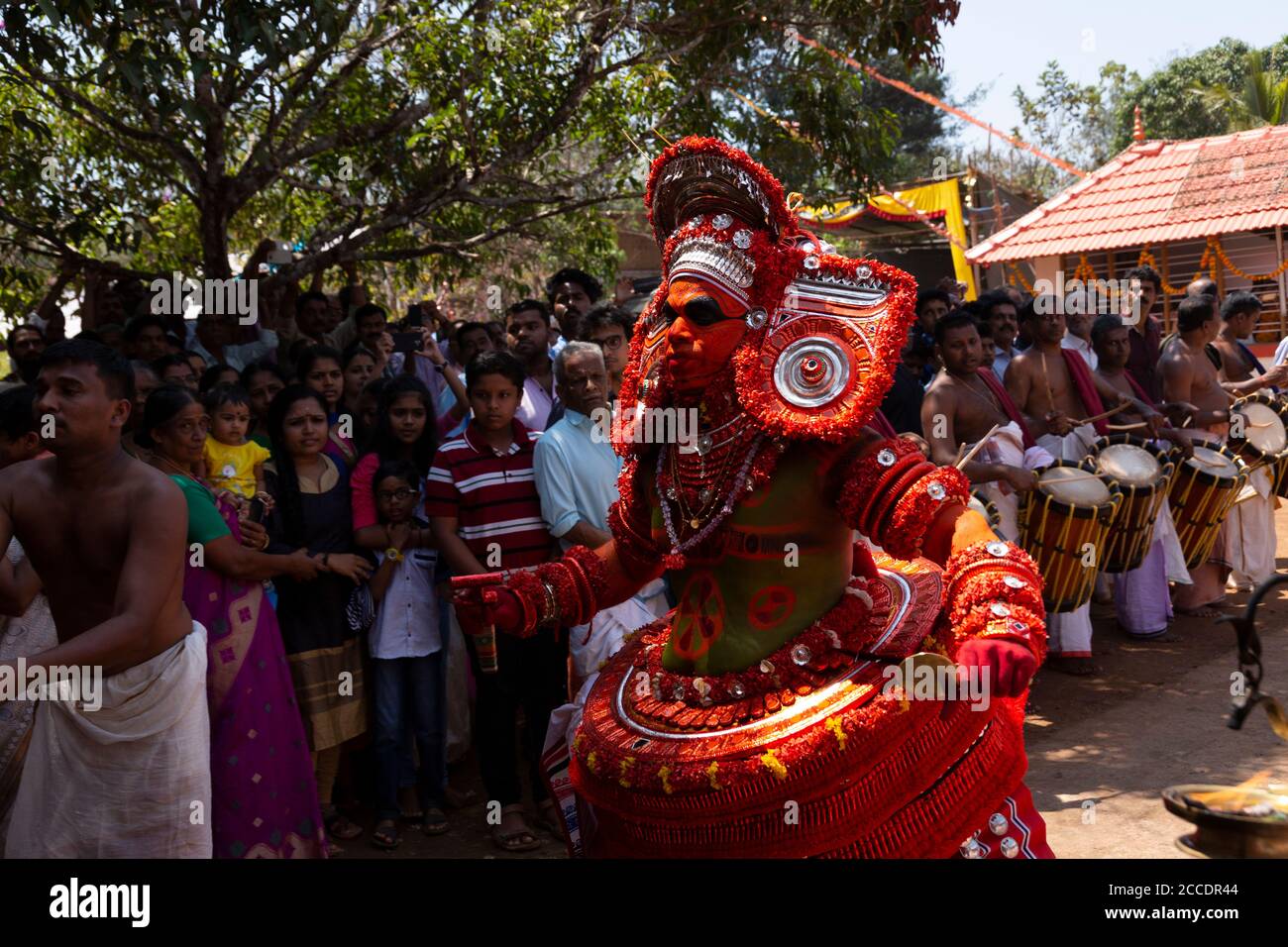 A Theyyam artist performs traditional rituals at a Kerala temple Stock ...
