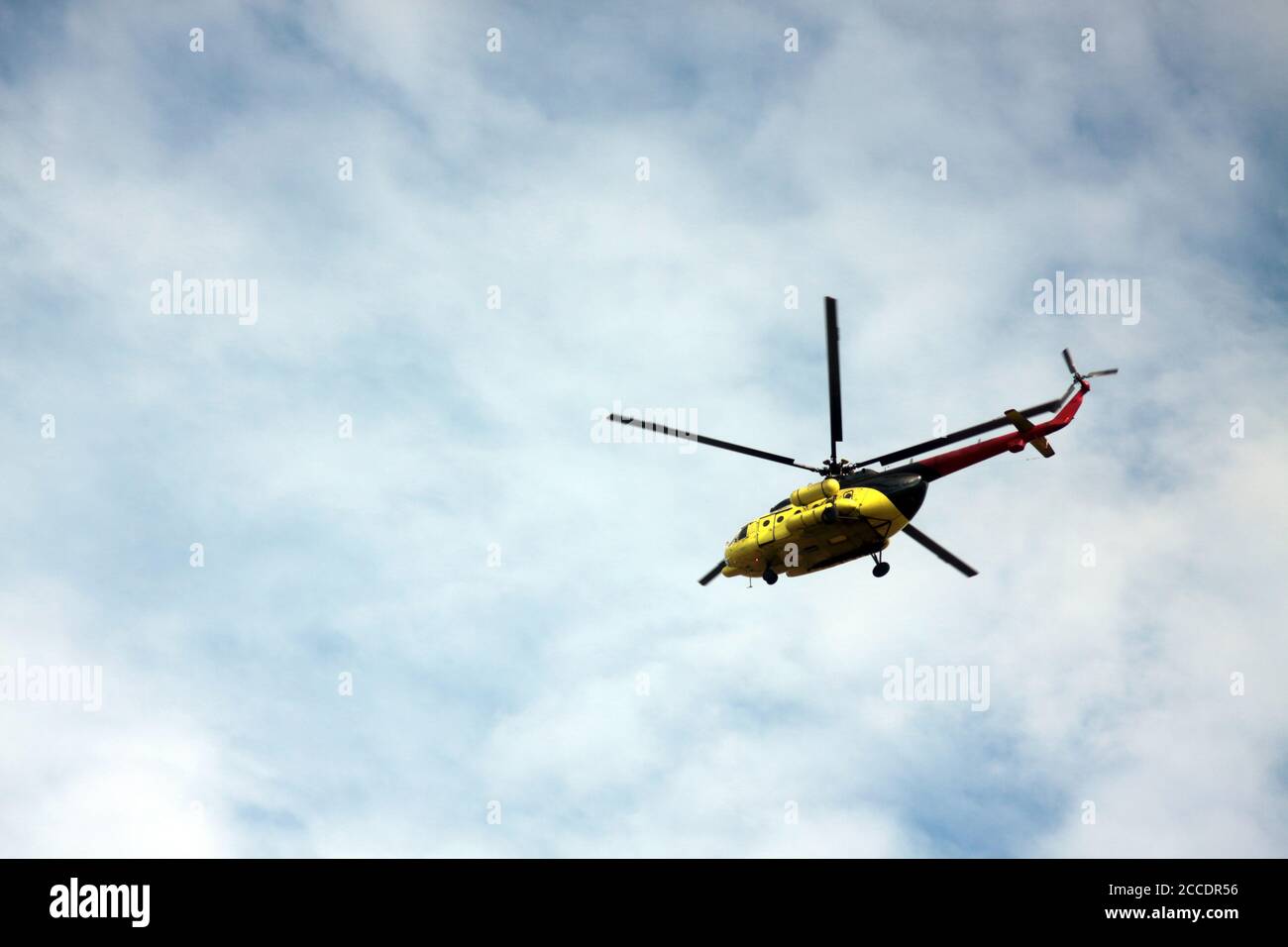 medevac helicopter flying in blue cloudy sky. Image contains copy space ...