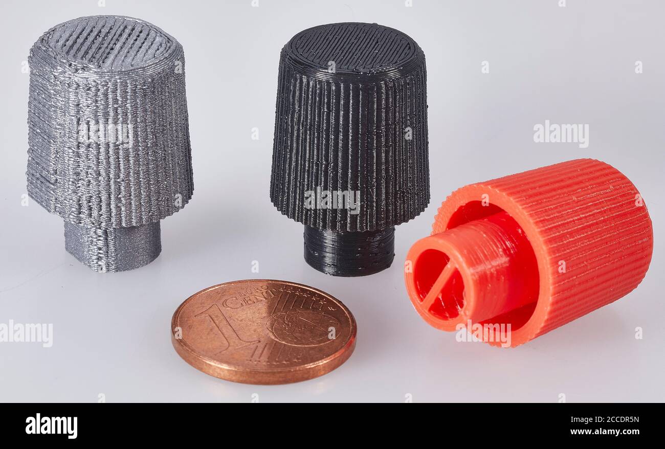 3d printed knobs cut out on white background, with coin for size ...