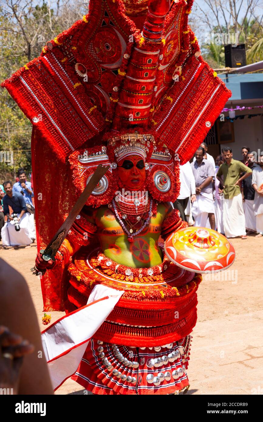 A Theyyam artist performing a ritual dance in a Kerala Temple Stock ...