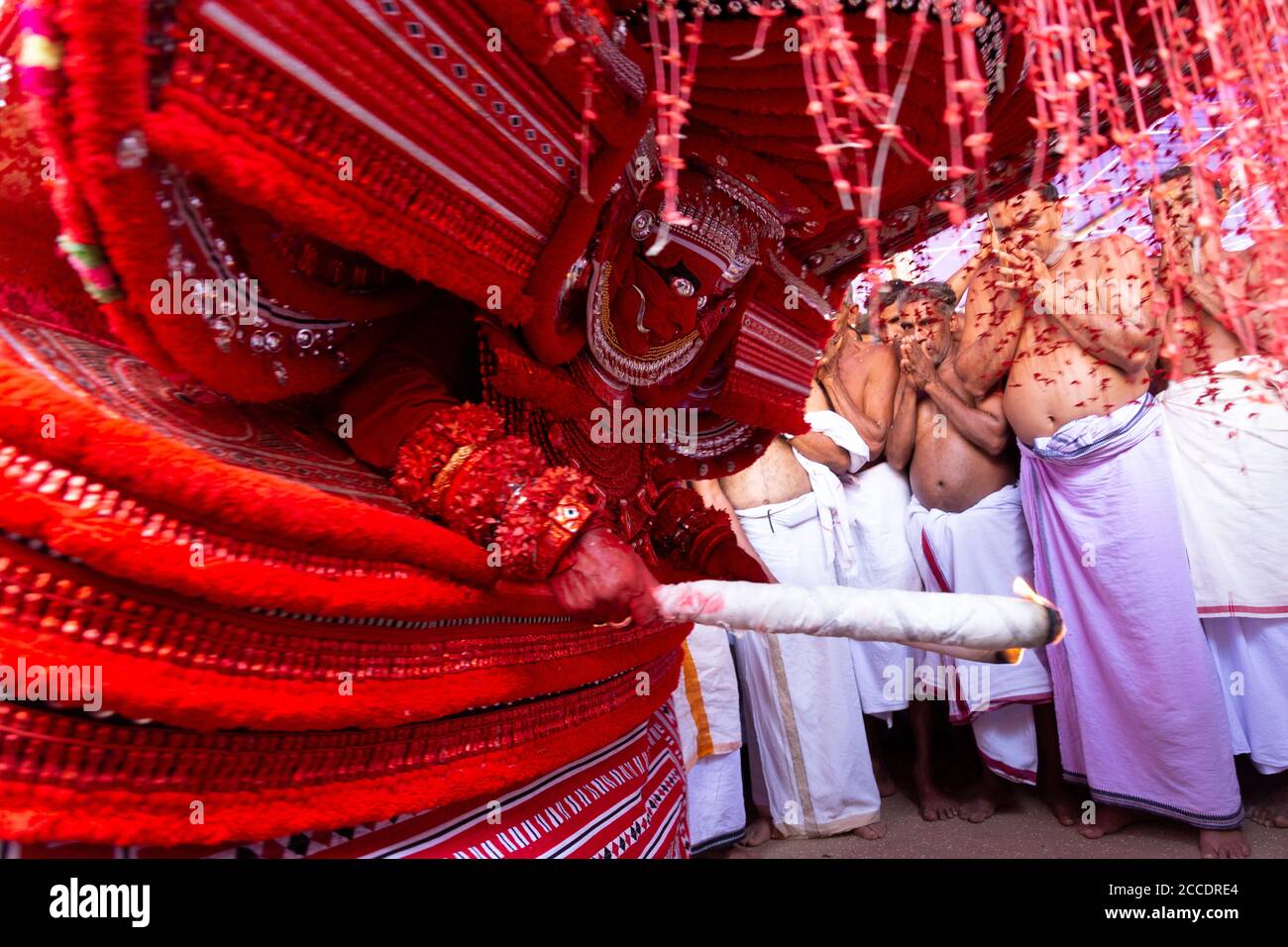 Traditional Theyyam performer adorned in elaborate costume and makeup ...
