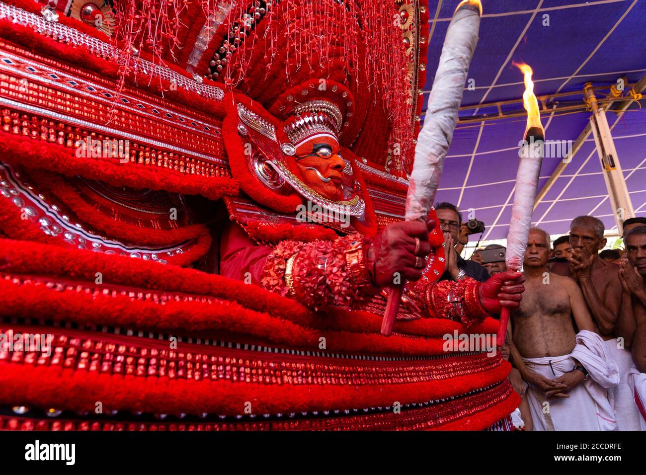 Traditional Theyyam performer adorned in elaborate costume and makeup ...
