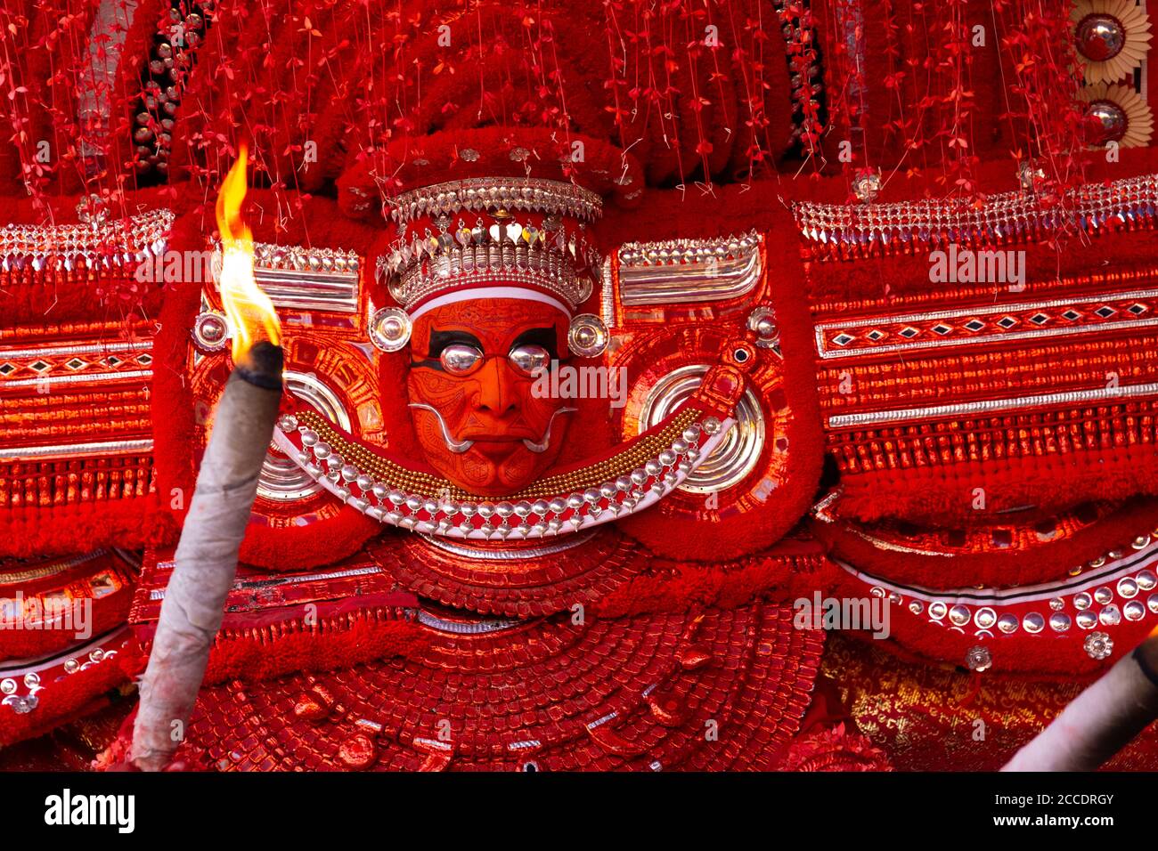 Traditional Theyyam performer adorned in elaborate costume and makeup ...