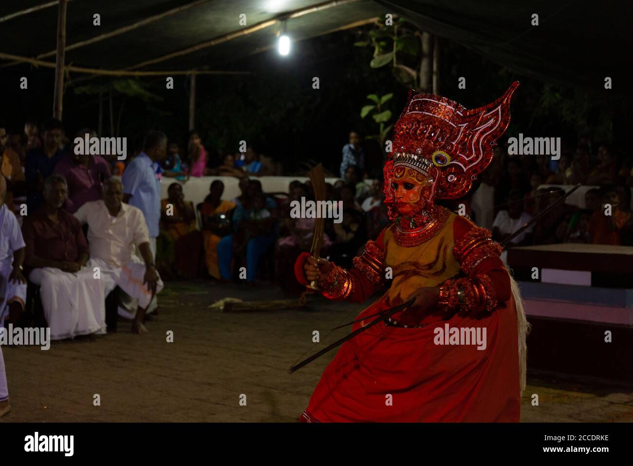 Traditional Theyyam performer adorned in elaborate costume and makeup ...