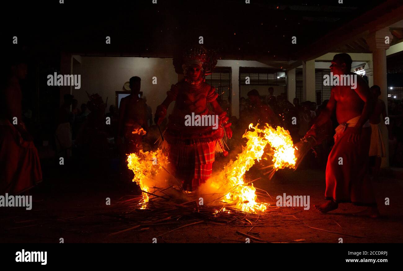 Kandanar Kelan Theyyam of northern Kerala, India jumping through fire ...