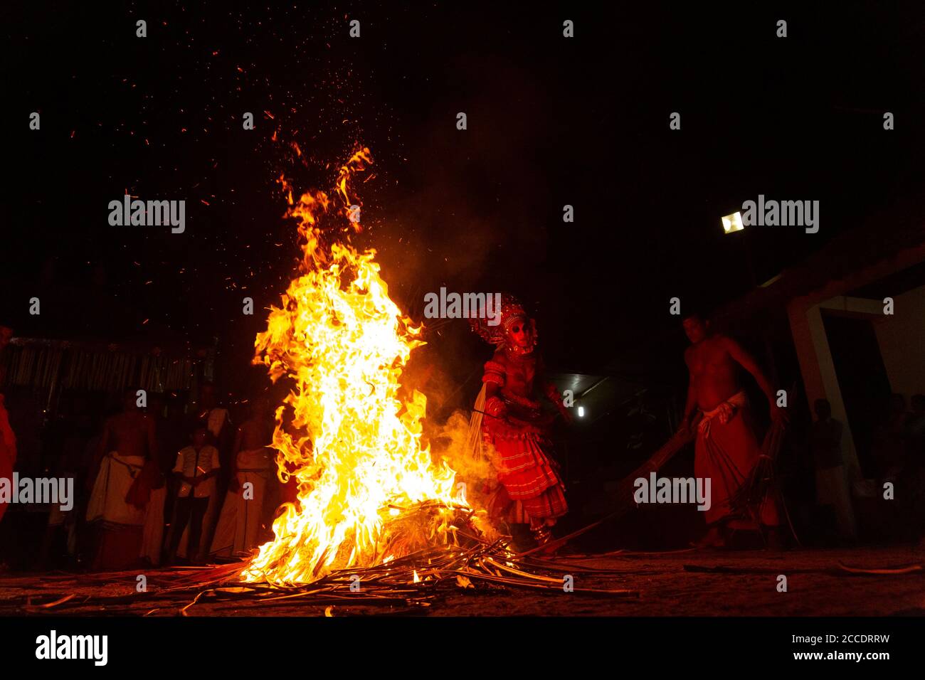 Kandanar Kelan Theyyam of northern Kerala, India jumping through fire ...