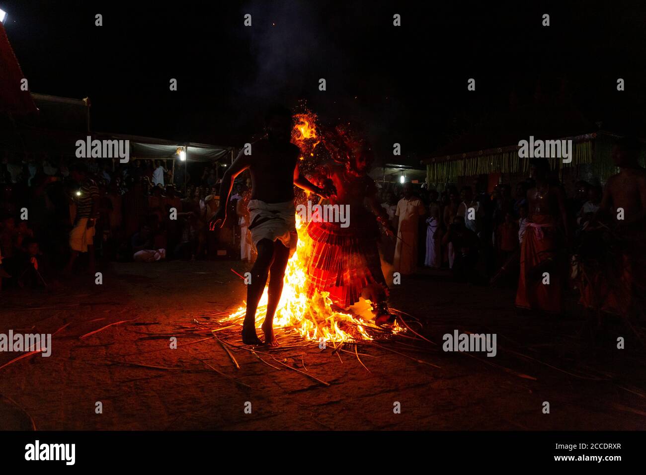 Kandanar Kelan Theyyam of northern Kerala, India jumping through fire ...
