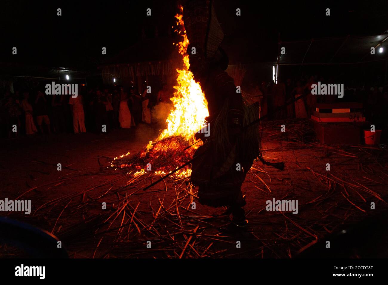 Kandanar Kelan Theyyam of northern Kerala, India jumping through fire ...