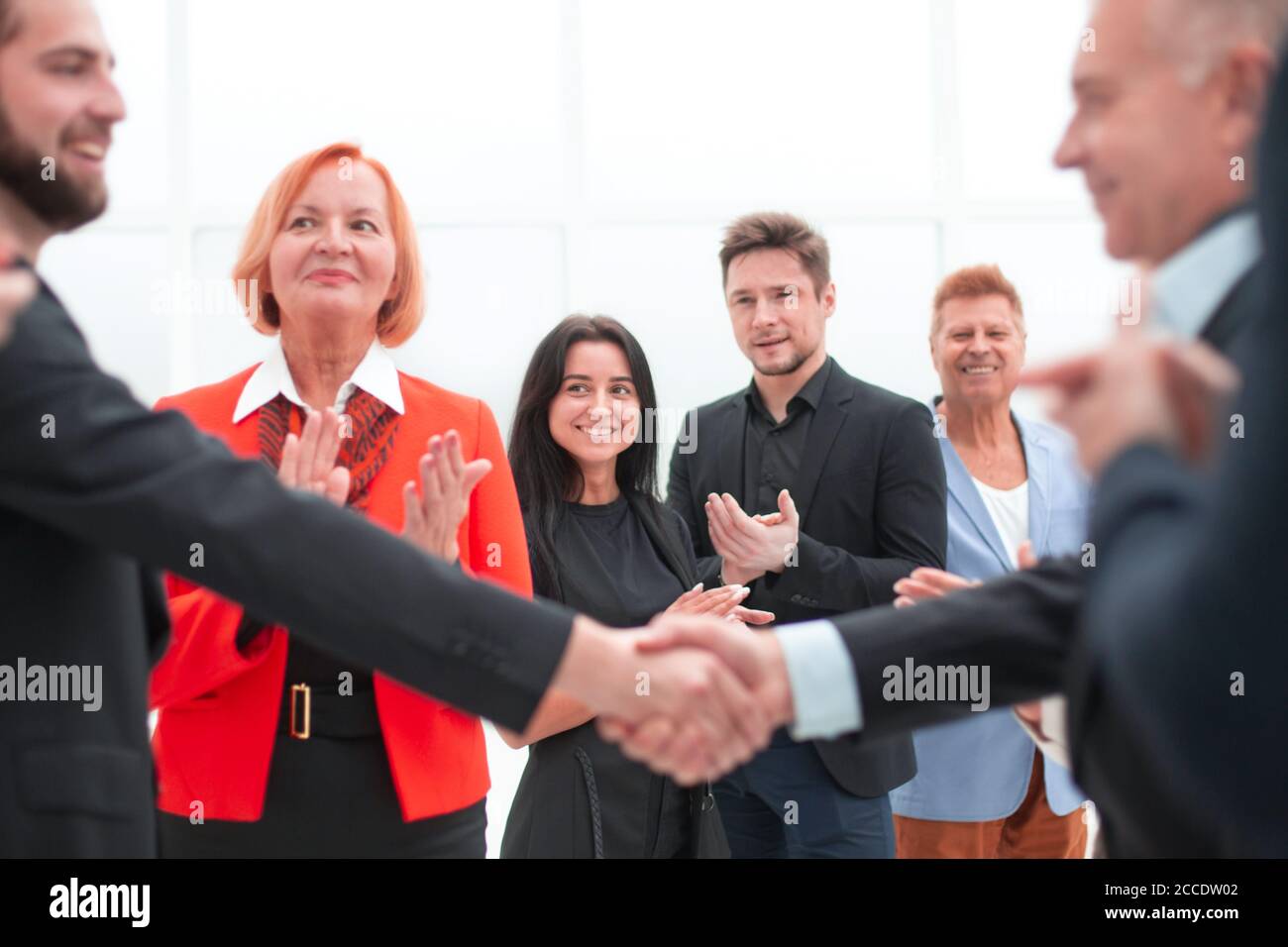Businessmen making handshake in an office Stock Photo - Alamy