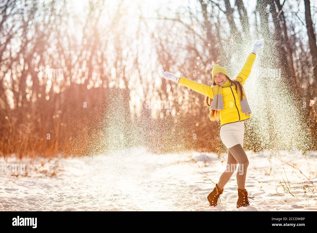 Winter snow fun woman playing throwing snow celebrating cold weather ...