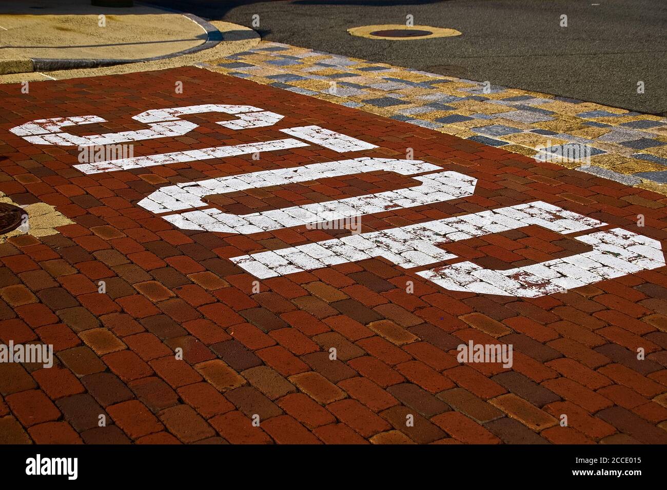 Vintage stop sign on city red brick floor Stock Photo - Alamy