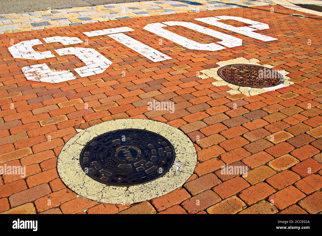 Vintage stop sign on city red brick floor Stock Photo - Alamy