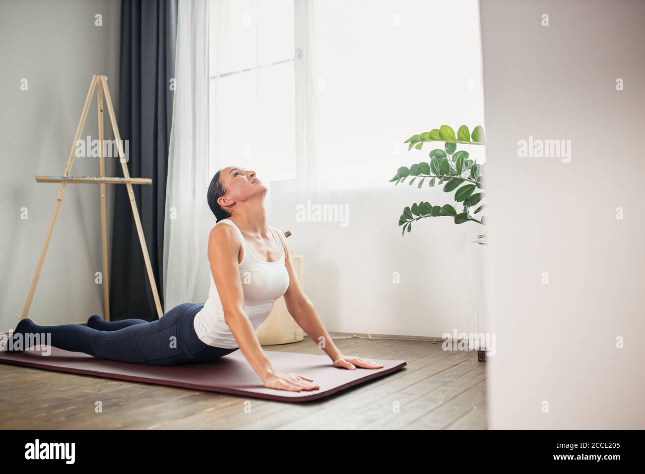 good-looking caucasian woman stretch neck and whole body on the floor ...