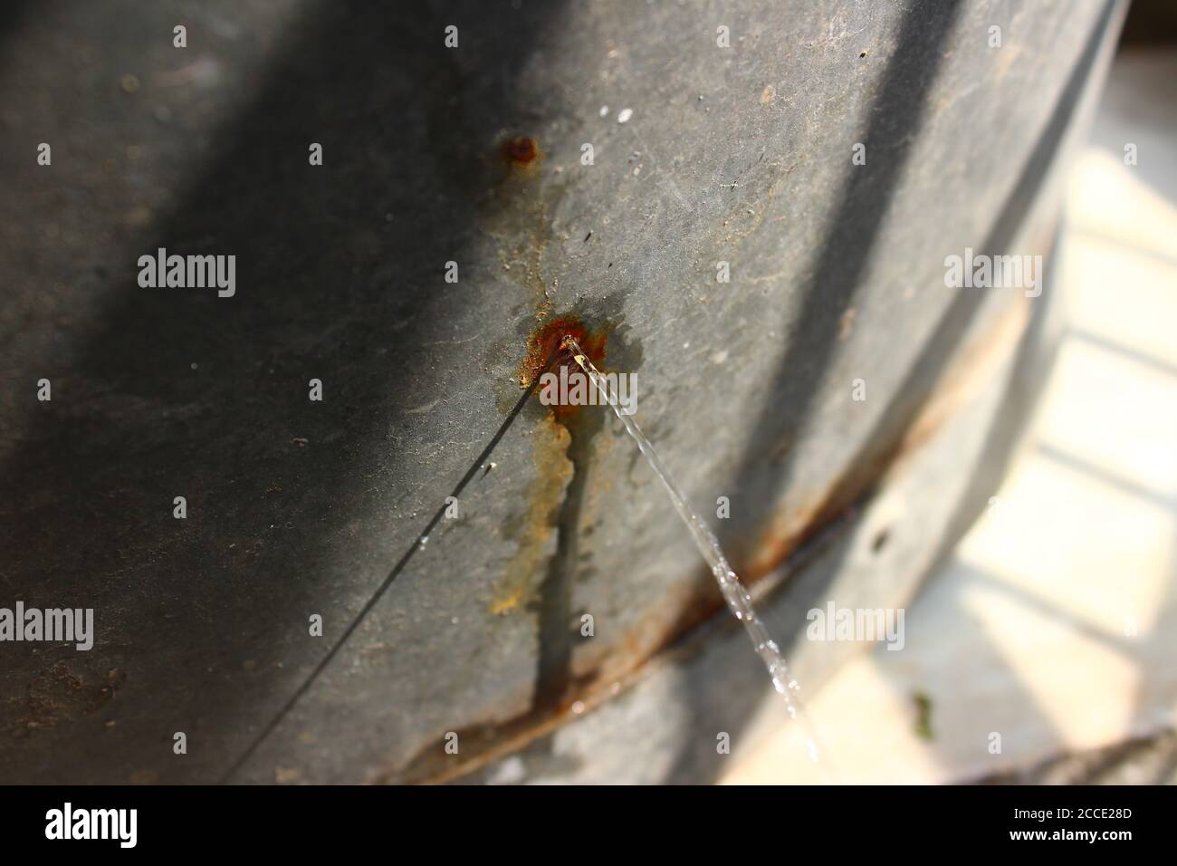 Water leakage from an old and rusty iron water tub Stock Photo - Alamy