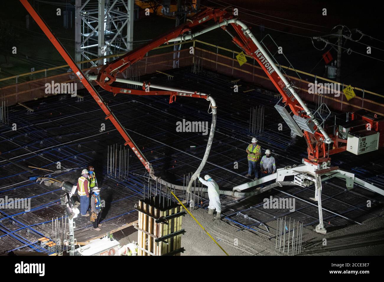 Austin, TX USA July 25, 2020: Pumped concrete flows through a tube onto ...