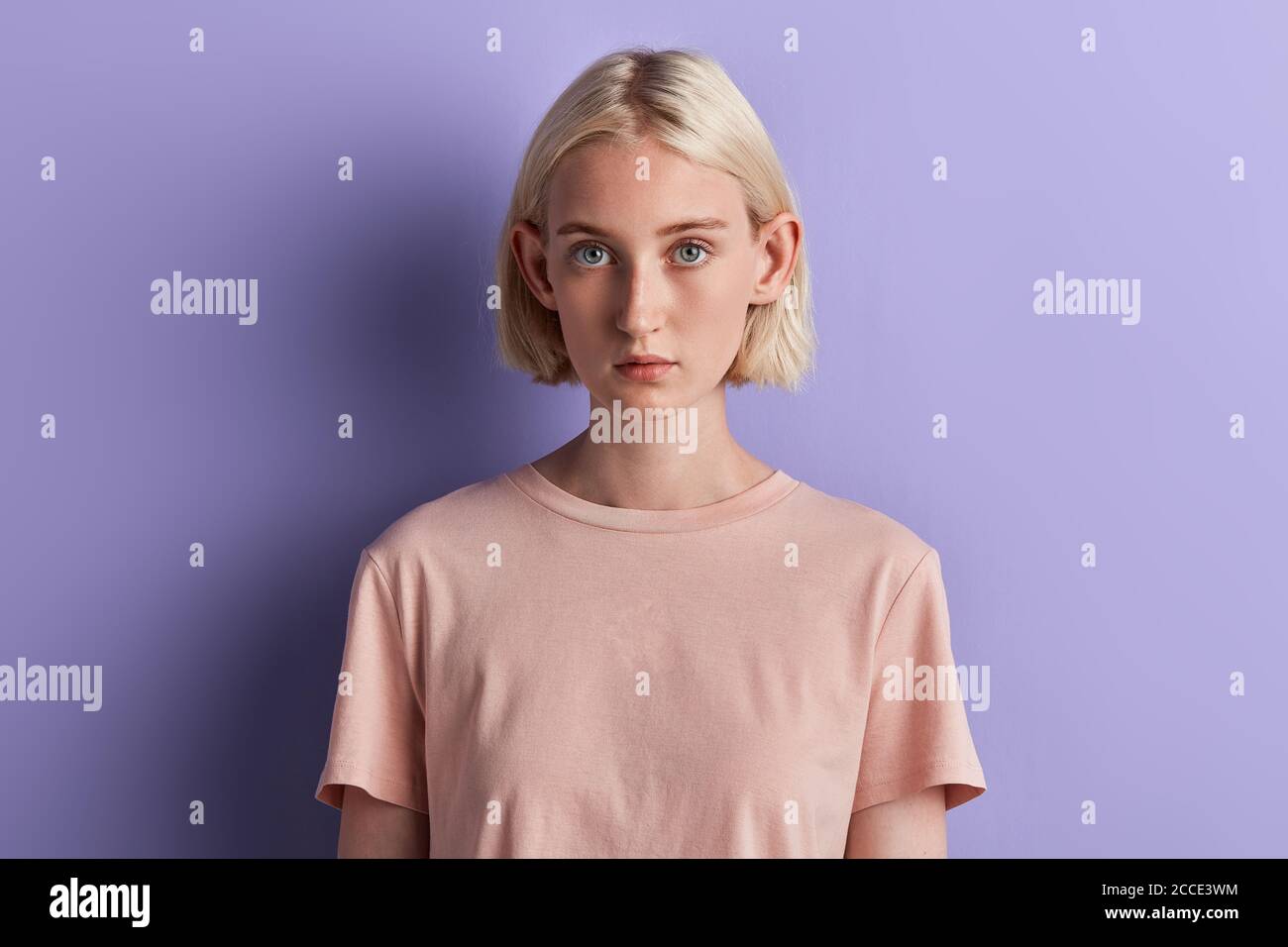 attractive young woman with big ears looking at the camera. close up ...