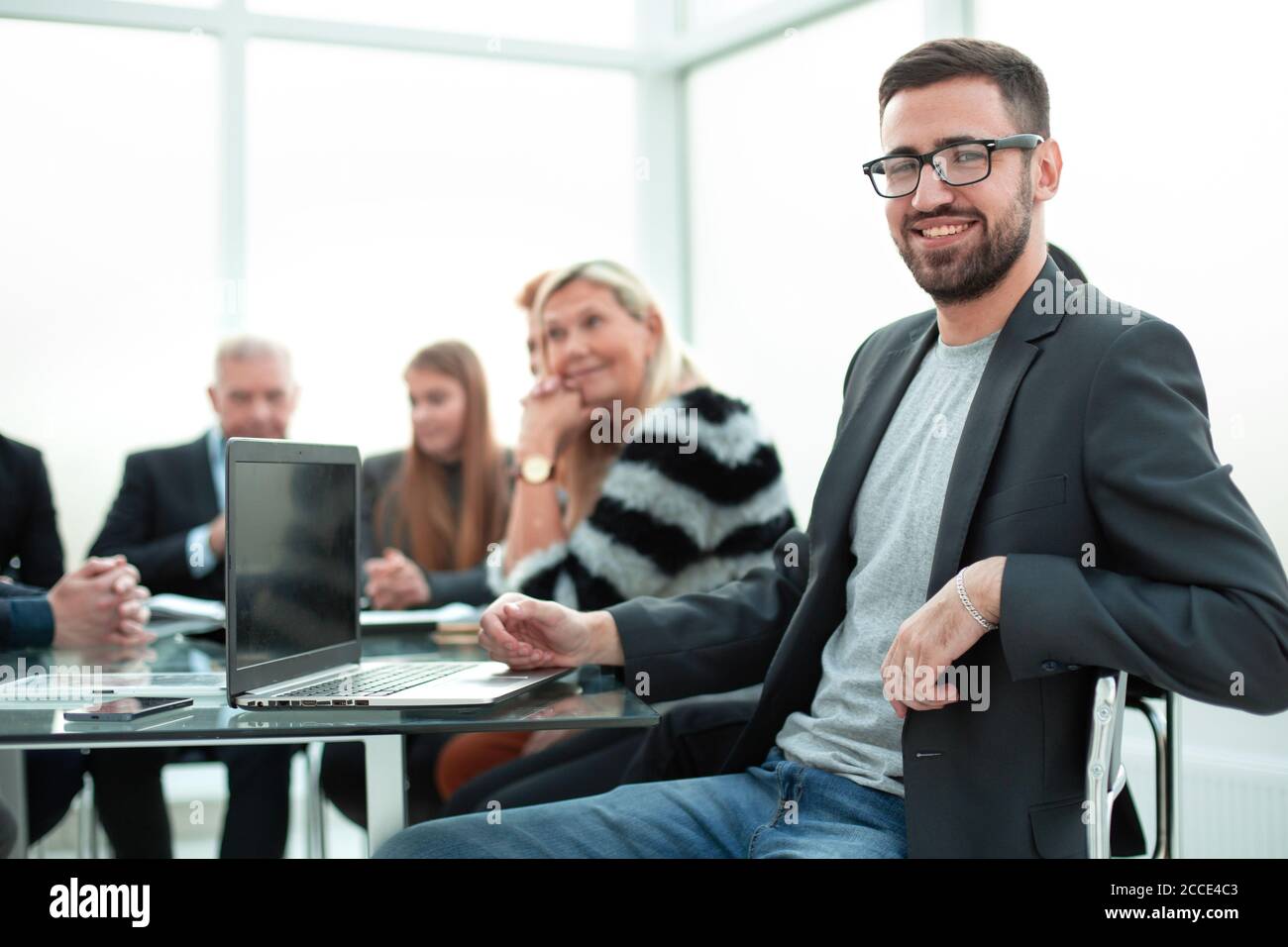 young business man looking at the camera in the office. business ...