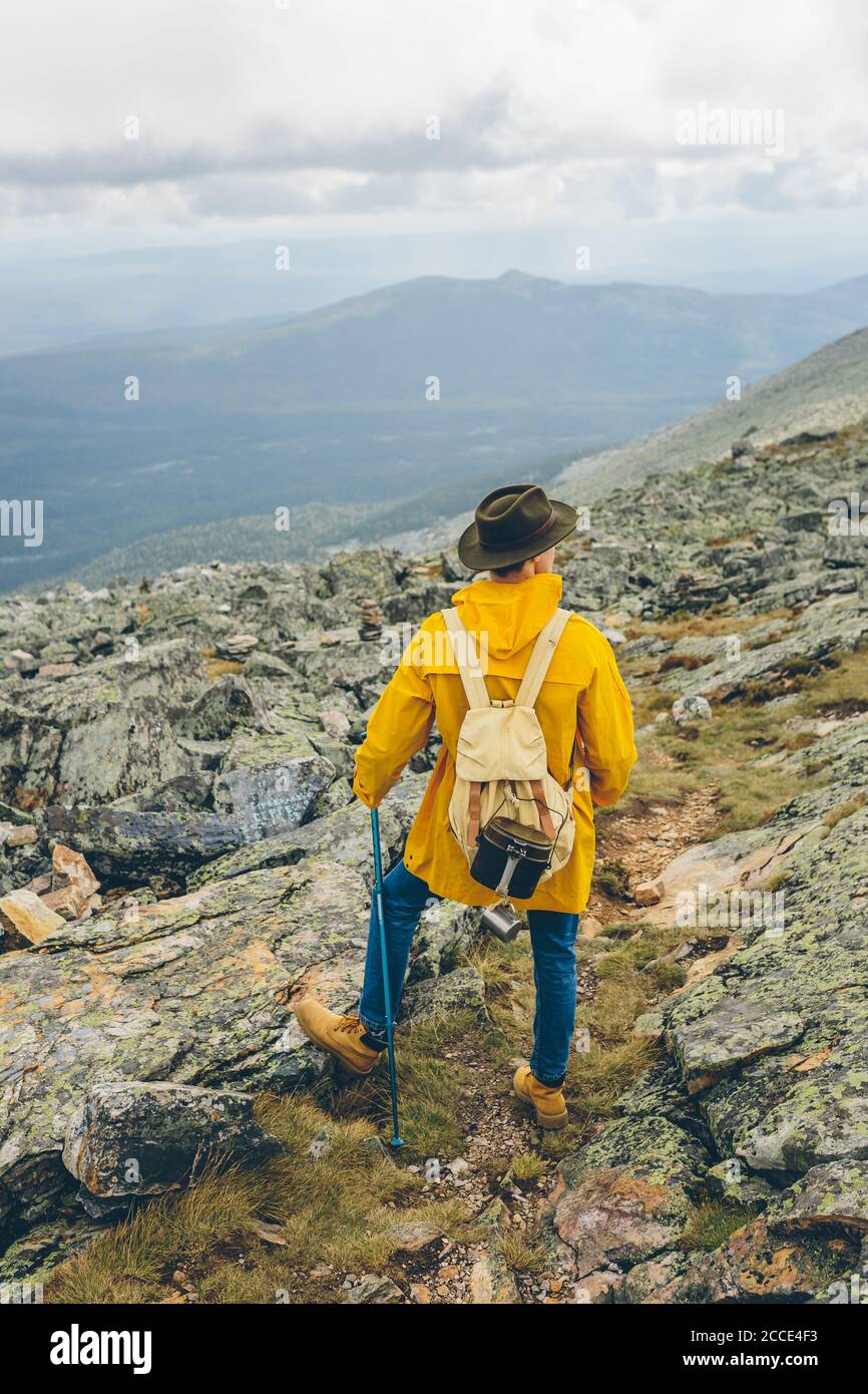 young hicker waiting for his friends who are going after him, back view ...