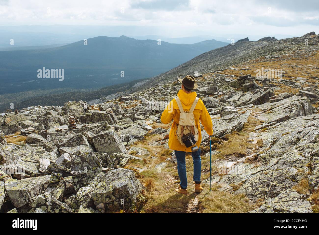 young motivated tourist looking at the horizon, full length back view ...