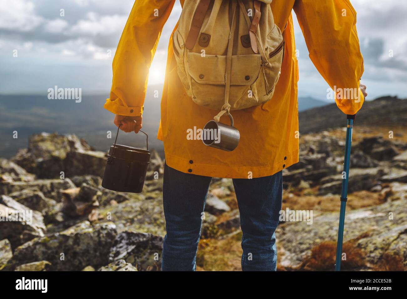Cropped image of a tourist walking along hiking trail with bucket ...