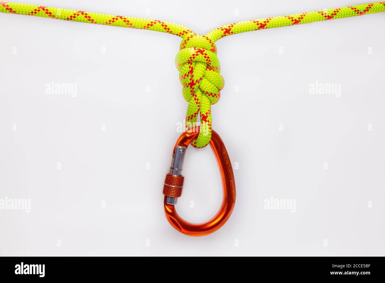 New red oval touristic and alpinistic carabine hangs from double figure ...