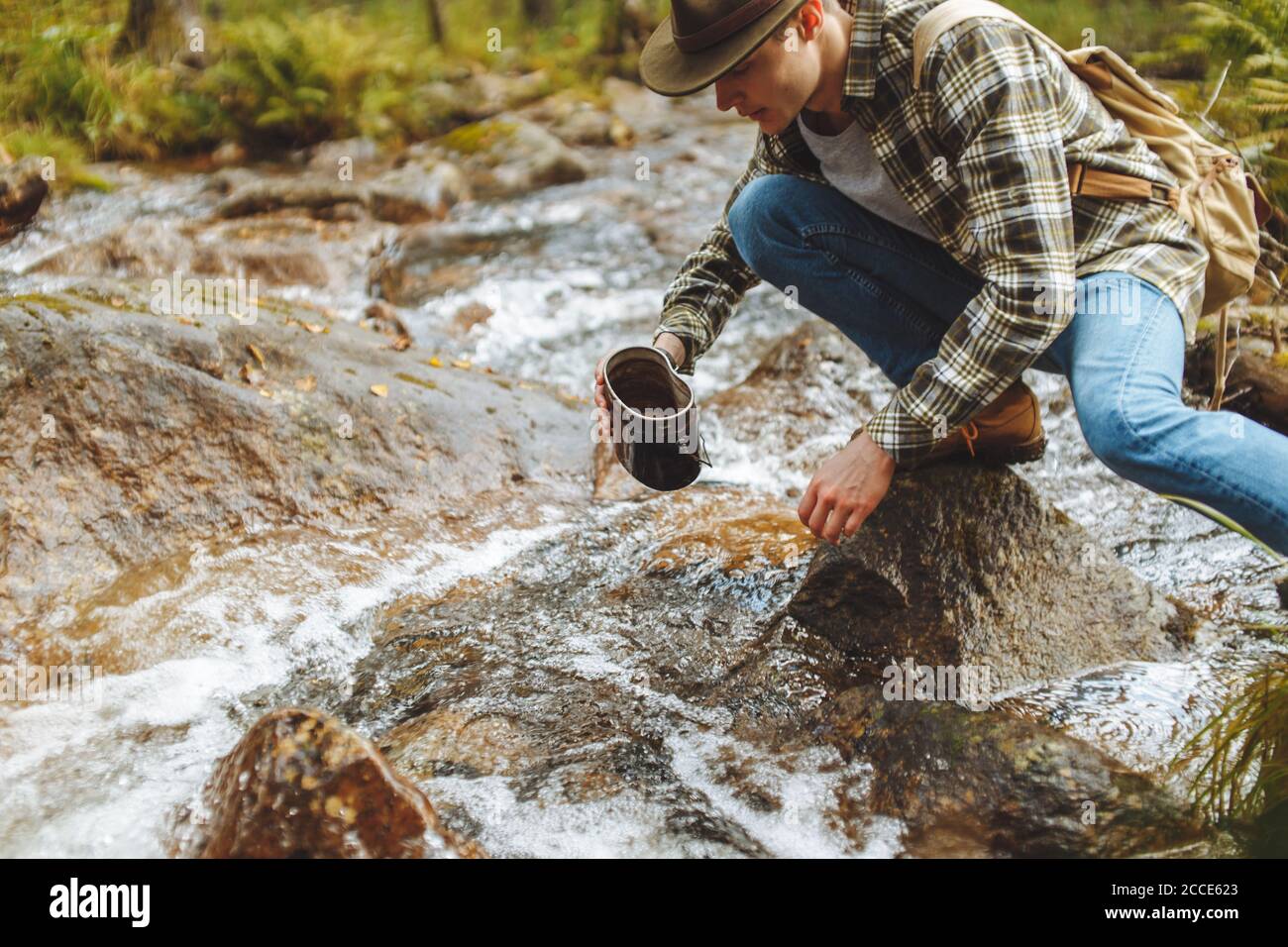Young man taking photo waterfall hi-res stock photography and images ...