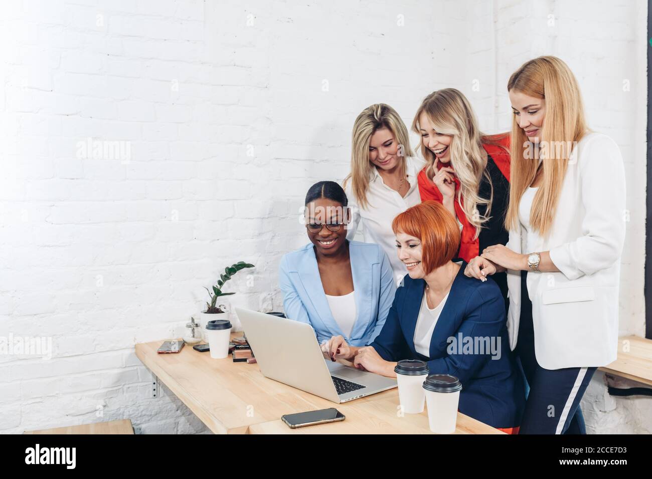 Red-haired teacher explaining new material on economics to her ...