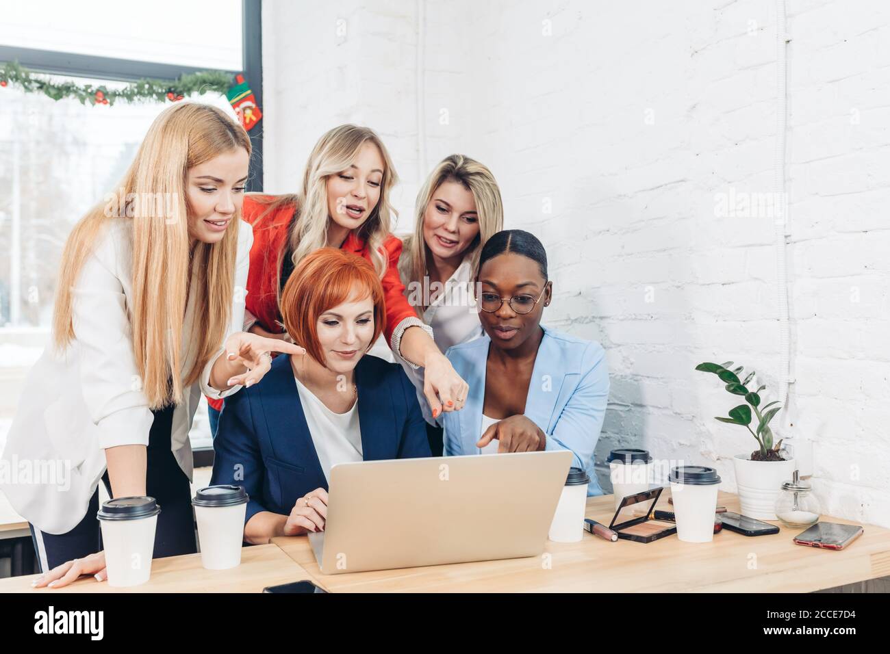 Red-haired teacher explaining new material on economics to her ...