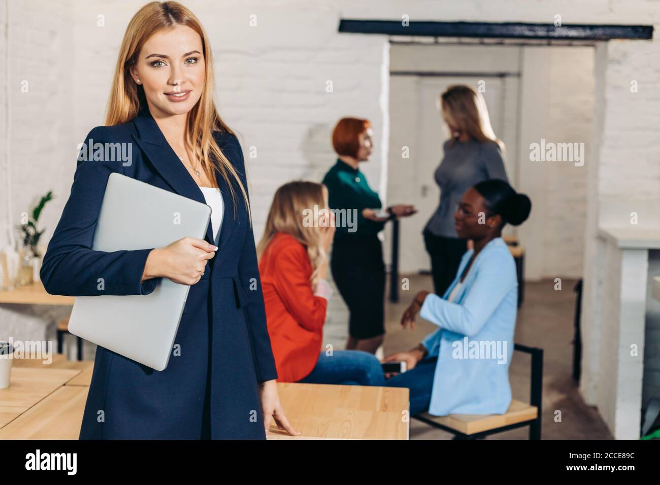 Confident caucasian female real estate agent holding laptop computer ...