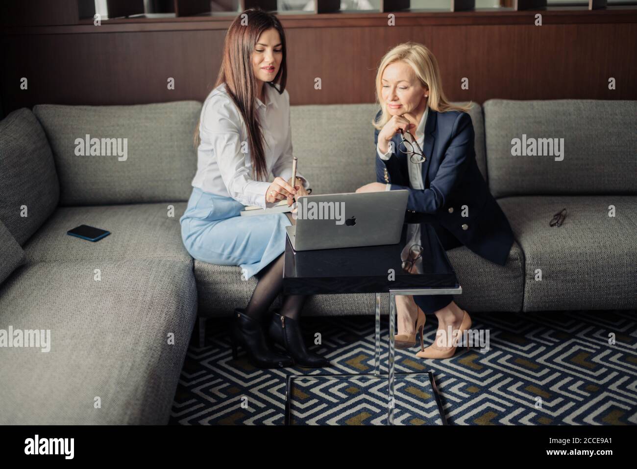 Brunette girl arranging meeting with female lowyer or tax advisor at ...