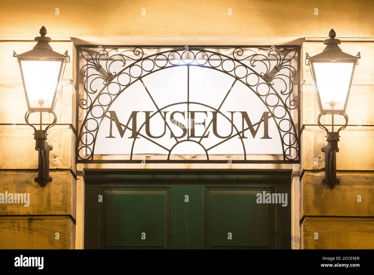 Museum sign over entrance door. Museum entrance lit up at night Stock ...