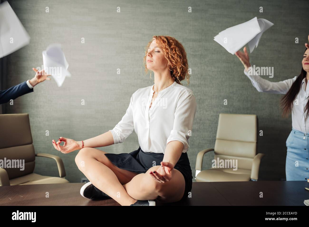 Relax concept. Serene business woman meditating in office putting aside ...