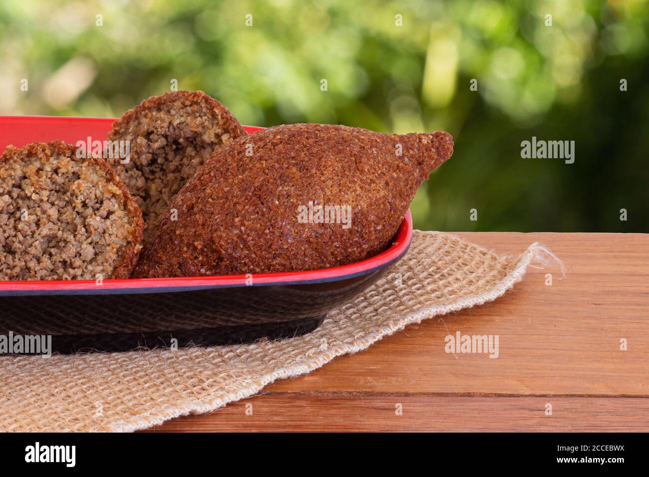 Kibe. Traditional Brazilian snack food. Isolated on green defocused ...