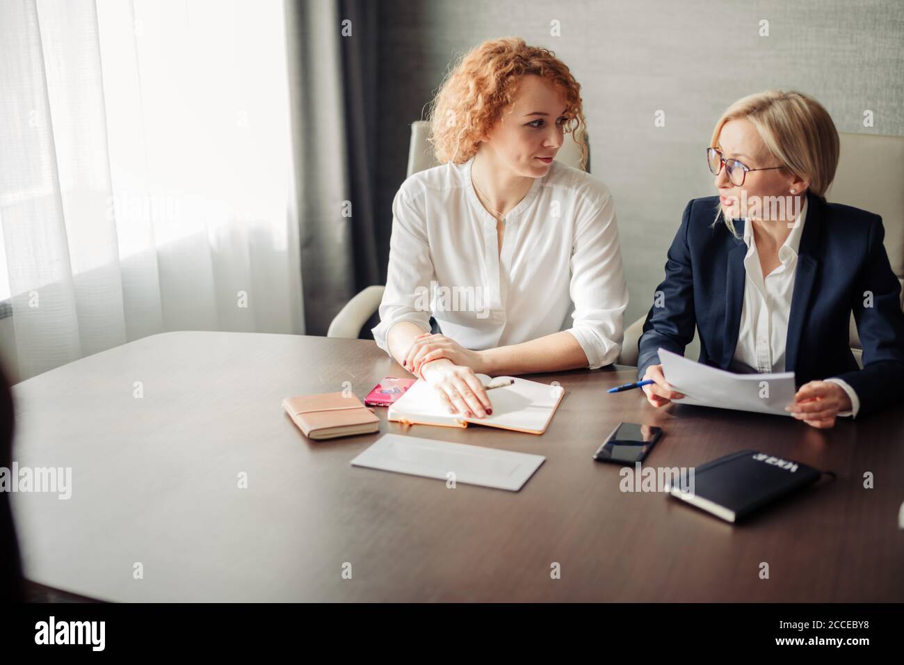 Two female human resources managers conducting job interview with woman ...