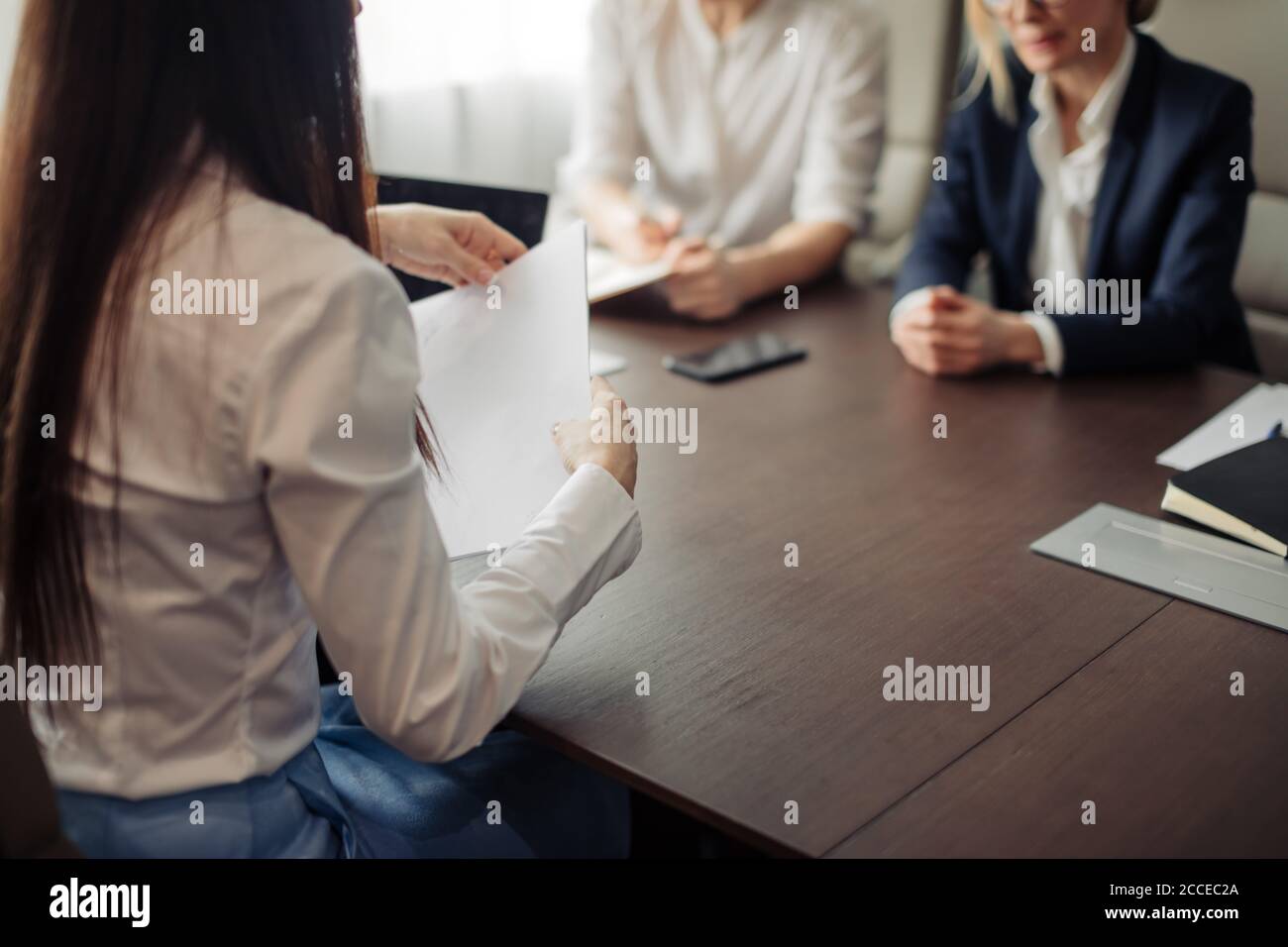 Two female human resources managers conducting job interview with woman ...
