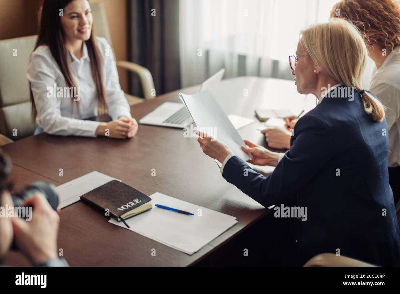 Two female human resources managers conducting job interview with woman ...